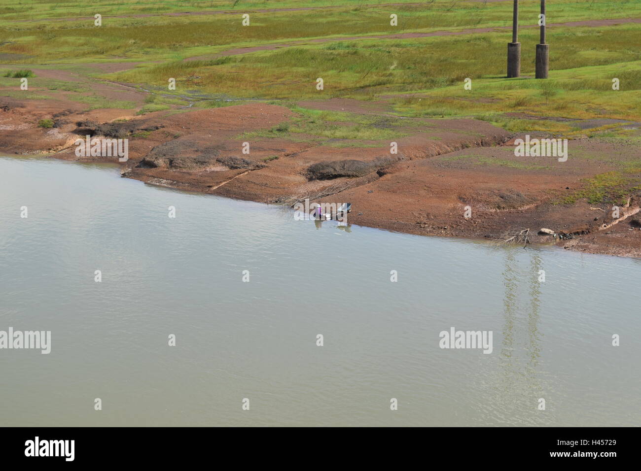 tropical river with the red soil bank Stock Photo - Alamy