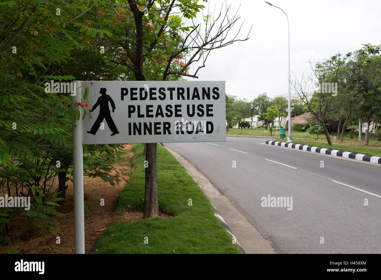 Pedestrian crossing sign with text Pedestrians Please Use Inner Road ...