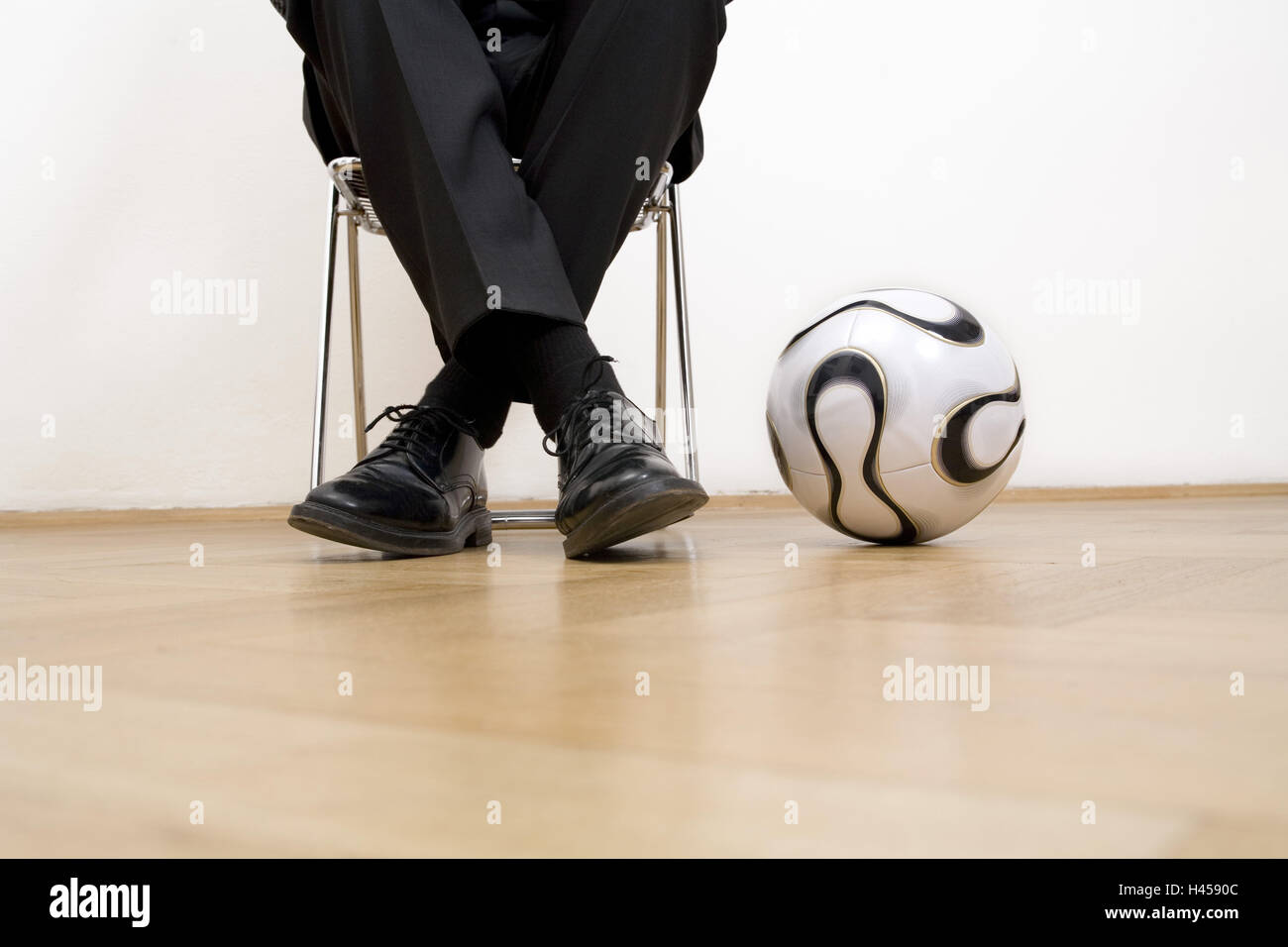 Sits businessman, chair,, Detail, wood floor, football, no property ...