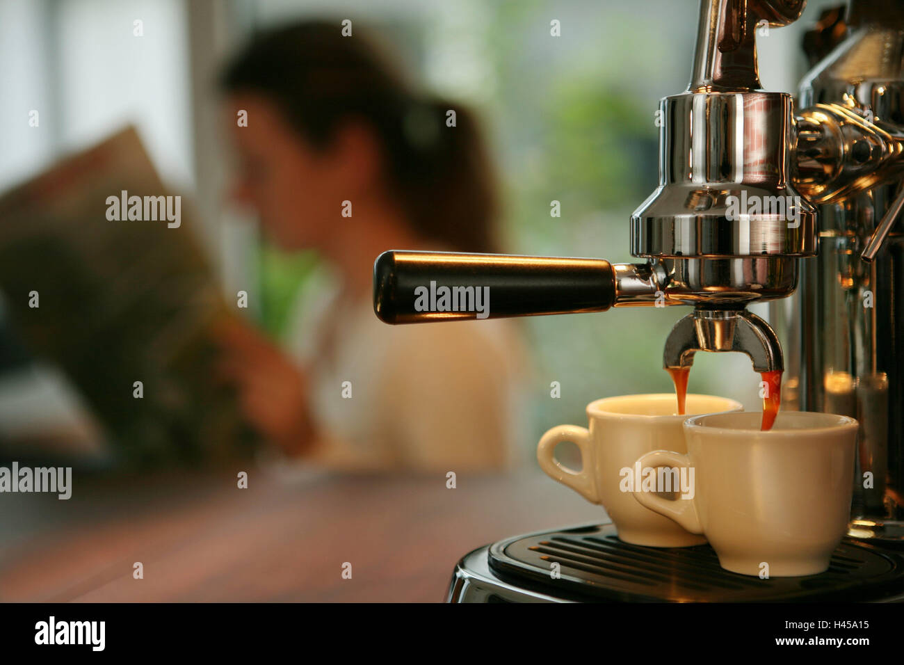 Espresso machine, cups, detail, background, blur, woman, newspaper ...