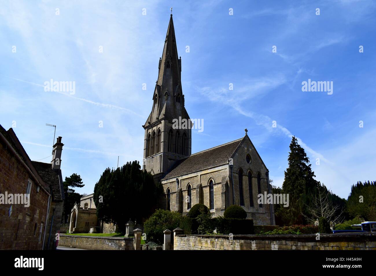 Ketton Church blue sky backdrop Stock Photo - Alamy