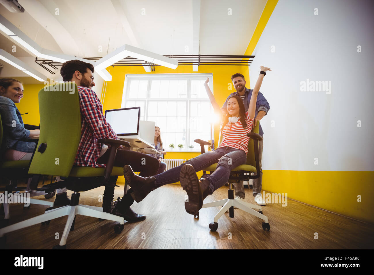 Happy colleagues enjoying at creative office Stock Photo - Alamy