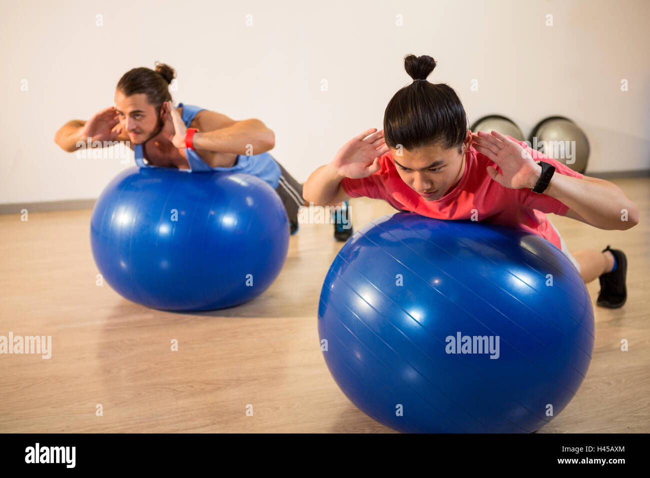 Men exercising on exercise ball Stock Photo - Alamy