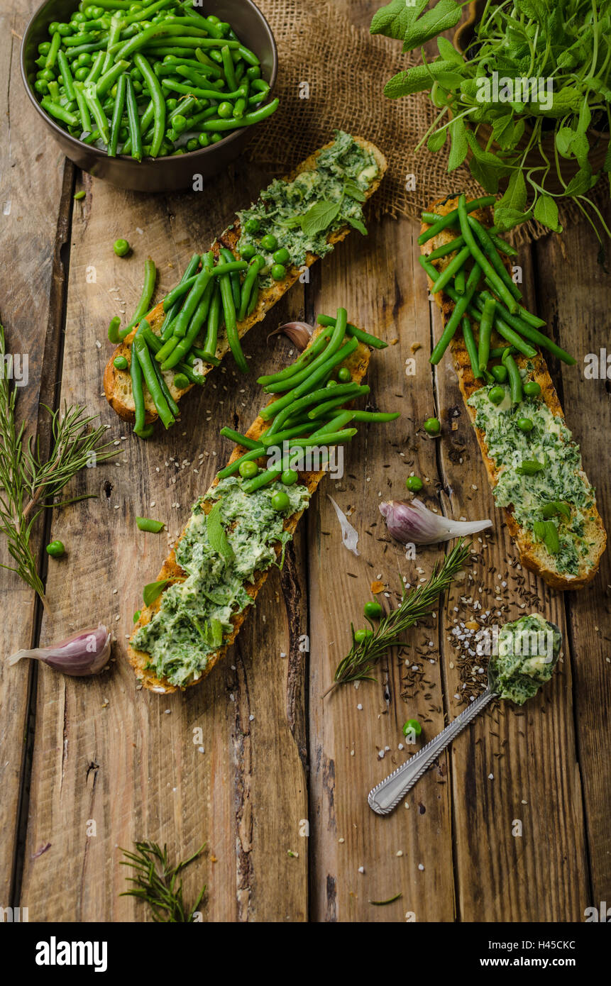 Healthy rustic baguette with herb butter and vegetables Stock Photo - Alamy