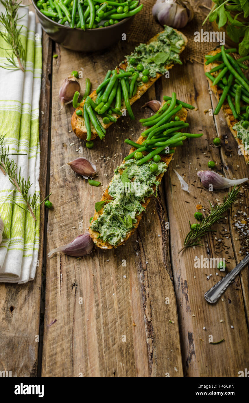 Healthy rustic baguette with herb butter and vegetables Stock Photo - Alamy