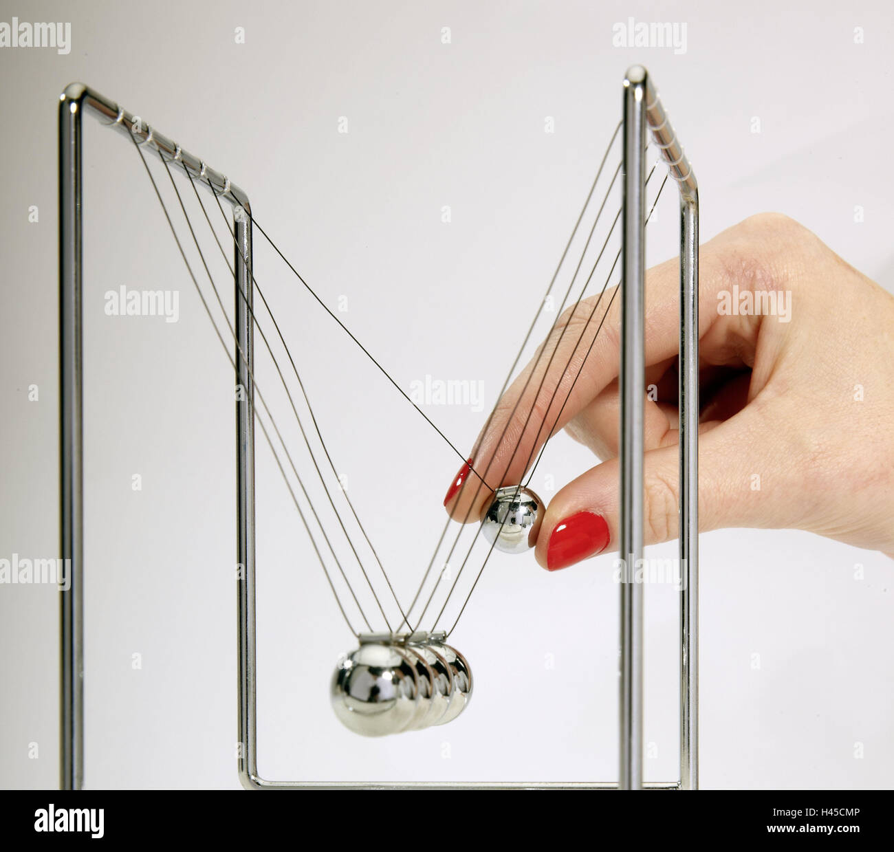 Newton's cradle and hand hi-res stock photography and images - Alamy
