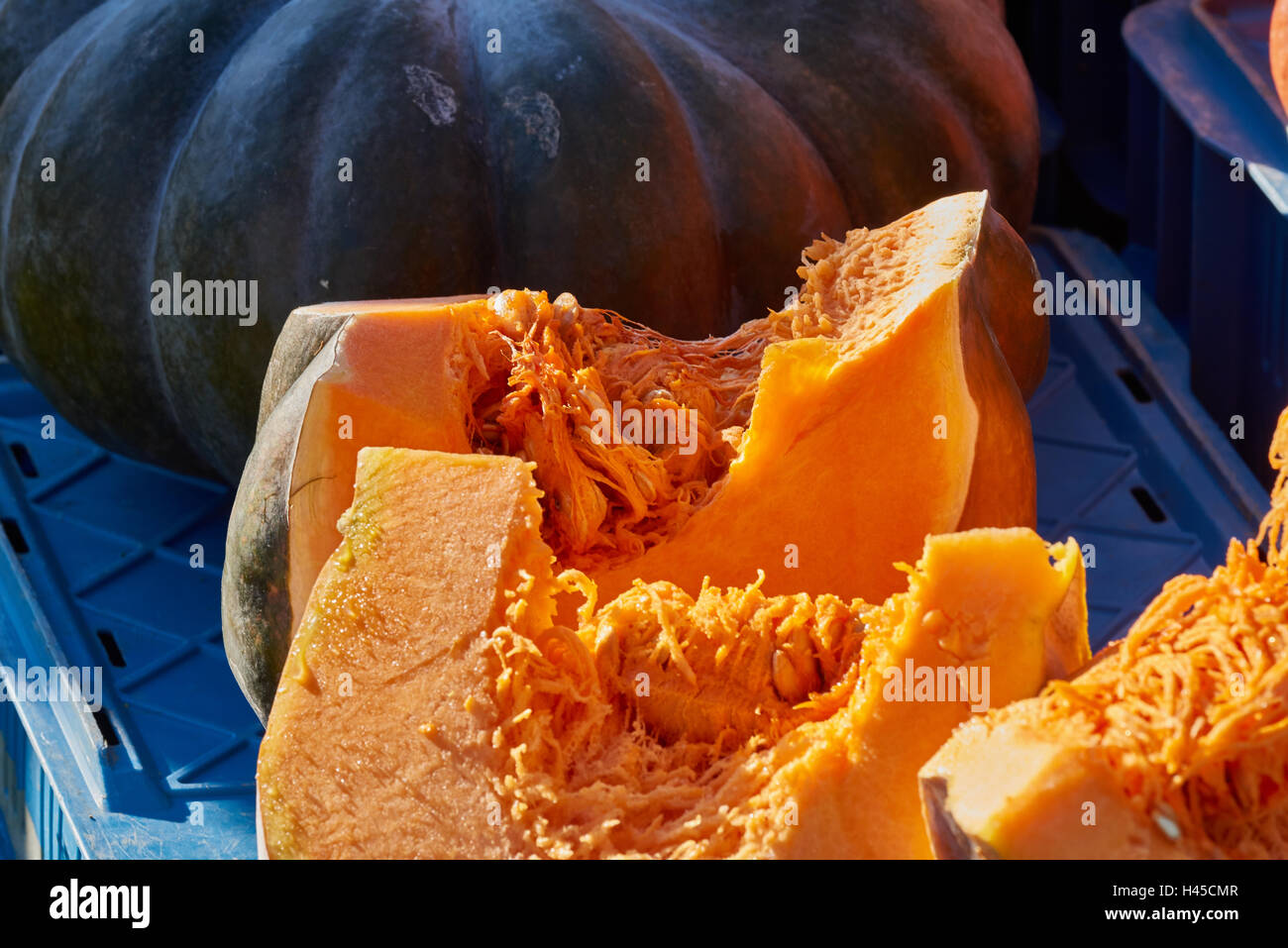 Sliced pumpkin with colorful orange fruit pulp inviting for taste on a ...