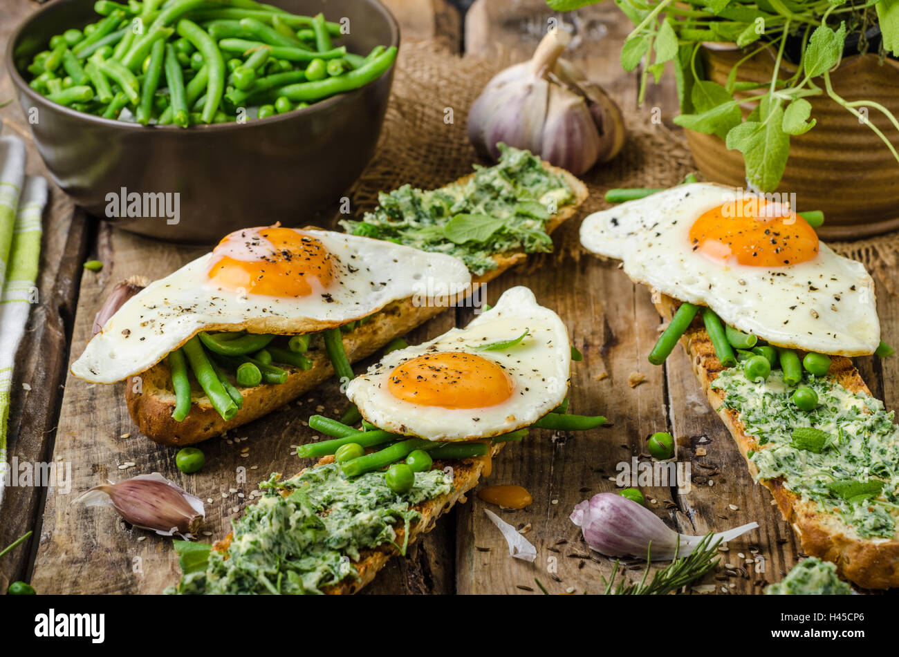 Healthy rustic baguette with herb butter and vegetables Stock Photo - Alamy