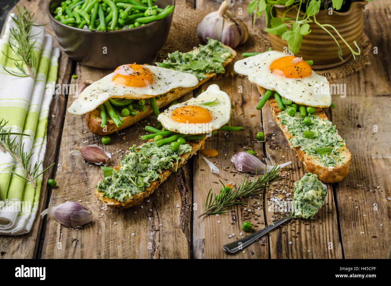 Healthy rustic baguette with herb butter and vegetables Stock Photo - Alamy