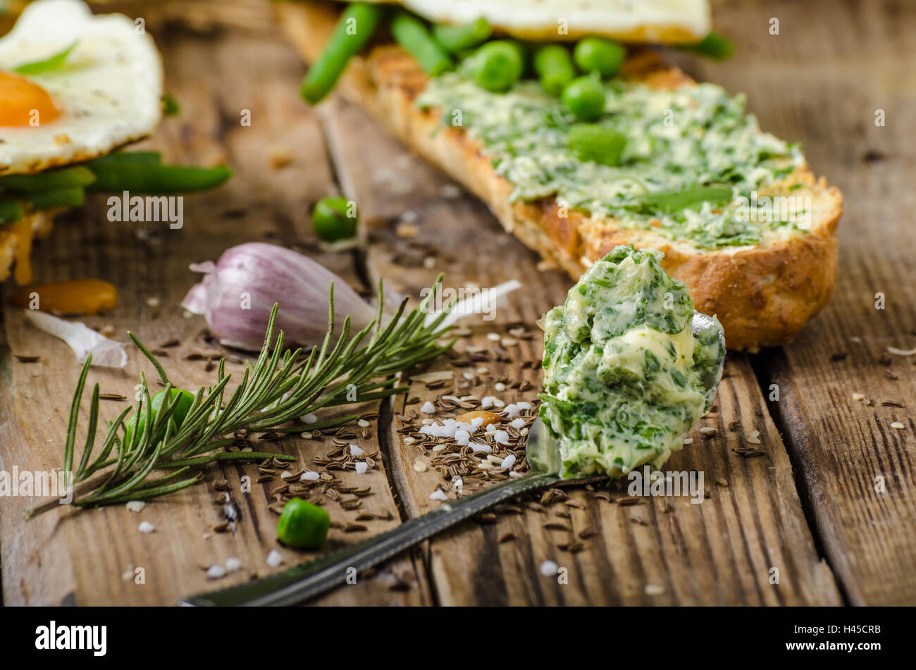 Healthy rustic baguette with herb butter and vegetables Stock Photo - Alamy