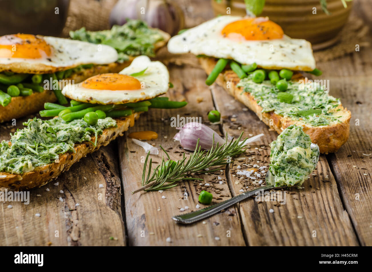 Healthy rustic baguette with herb butter and vegetables Stock Photo - Alamy
