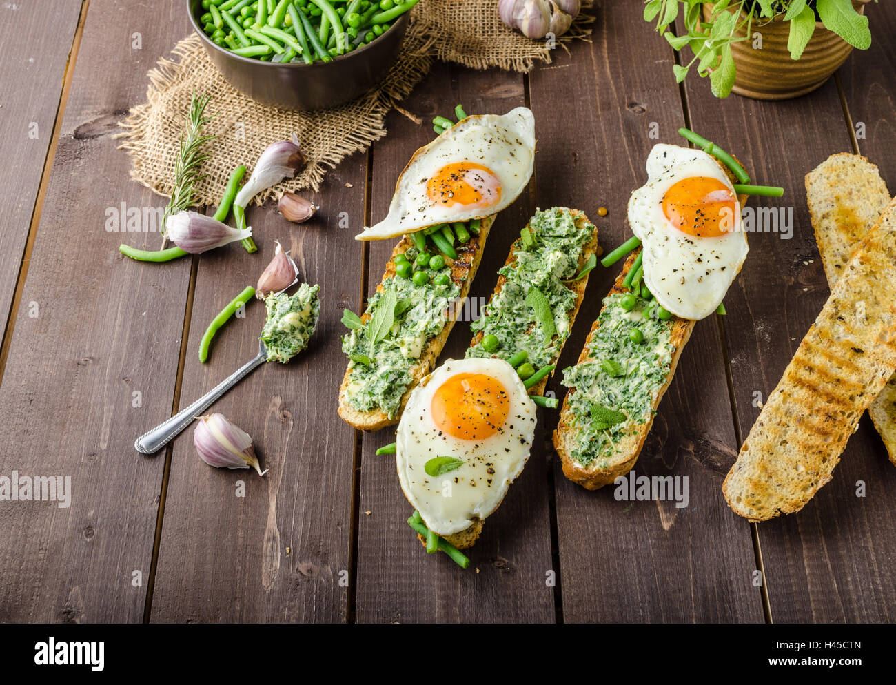 Healthy rustic baguette with herb butter and vegetables Stock Photo - Alamy