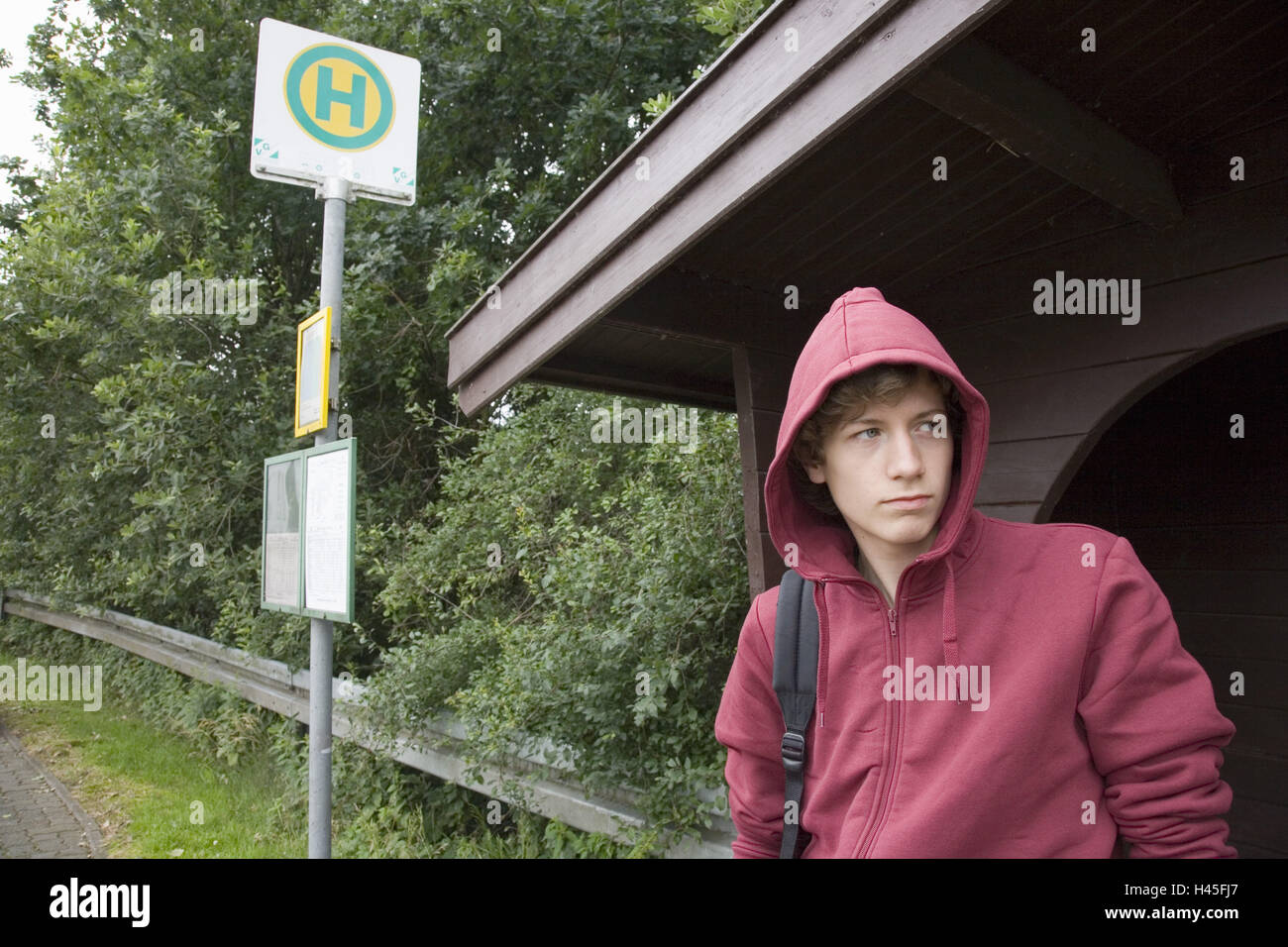 Boy, teenagers, bus stop, wait, stand Stock Photo - Alamy