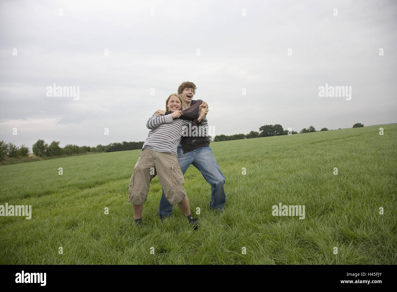 Boys, teenagers, two, meadow, tussle Stock Photo - Alamy
