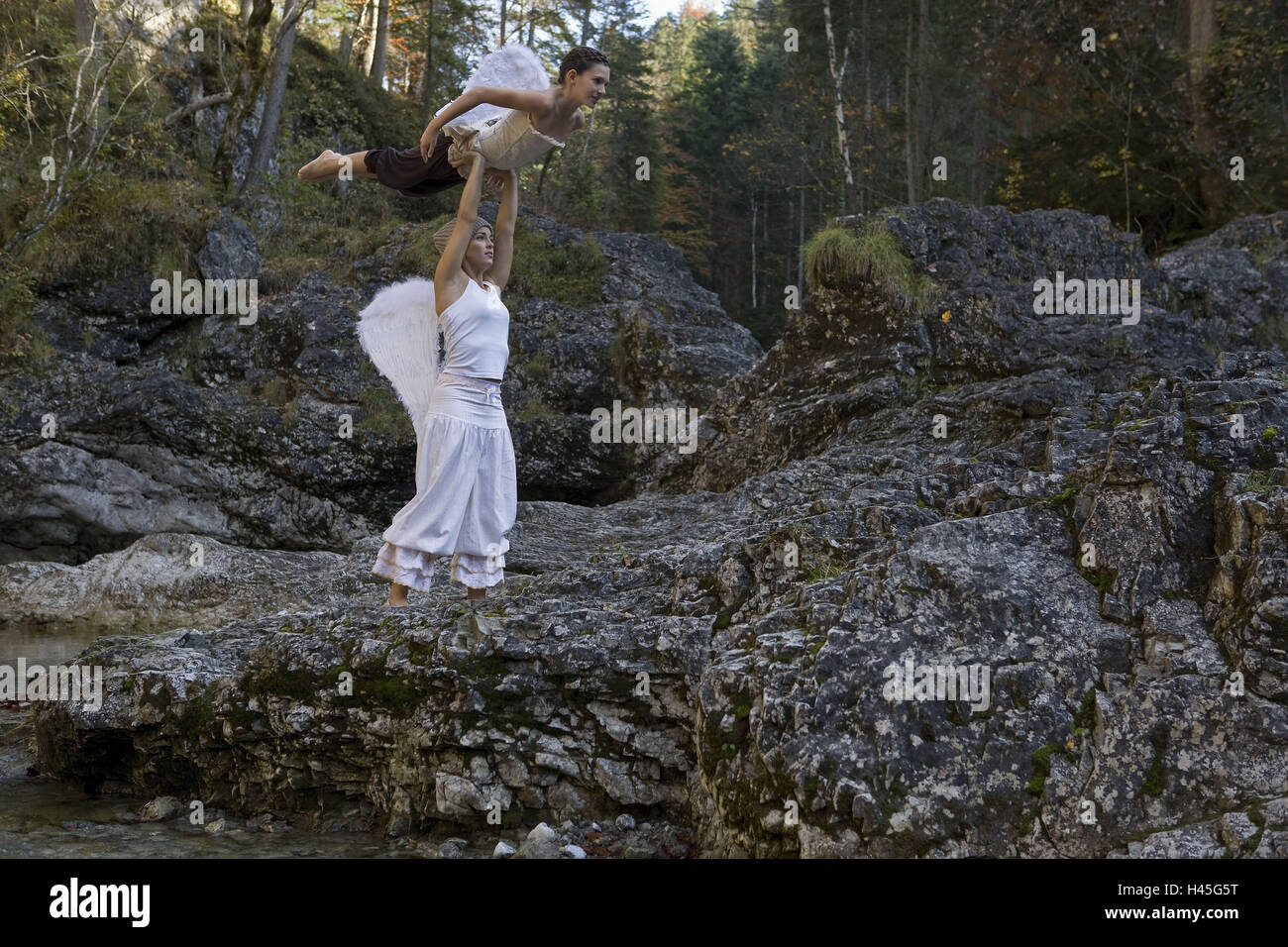 Girls, two, angel, lift Stock Photo - Alamy