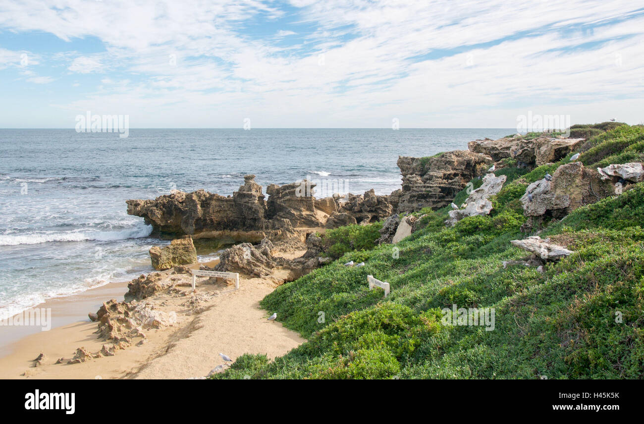 Rugged limestone outcropping and remote beach with the Indian Ocean ...