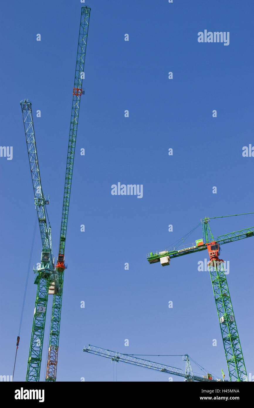 Men at work, construction cranes, from below Stock Photo - Alamy