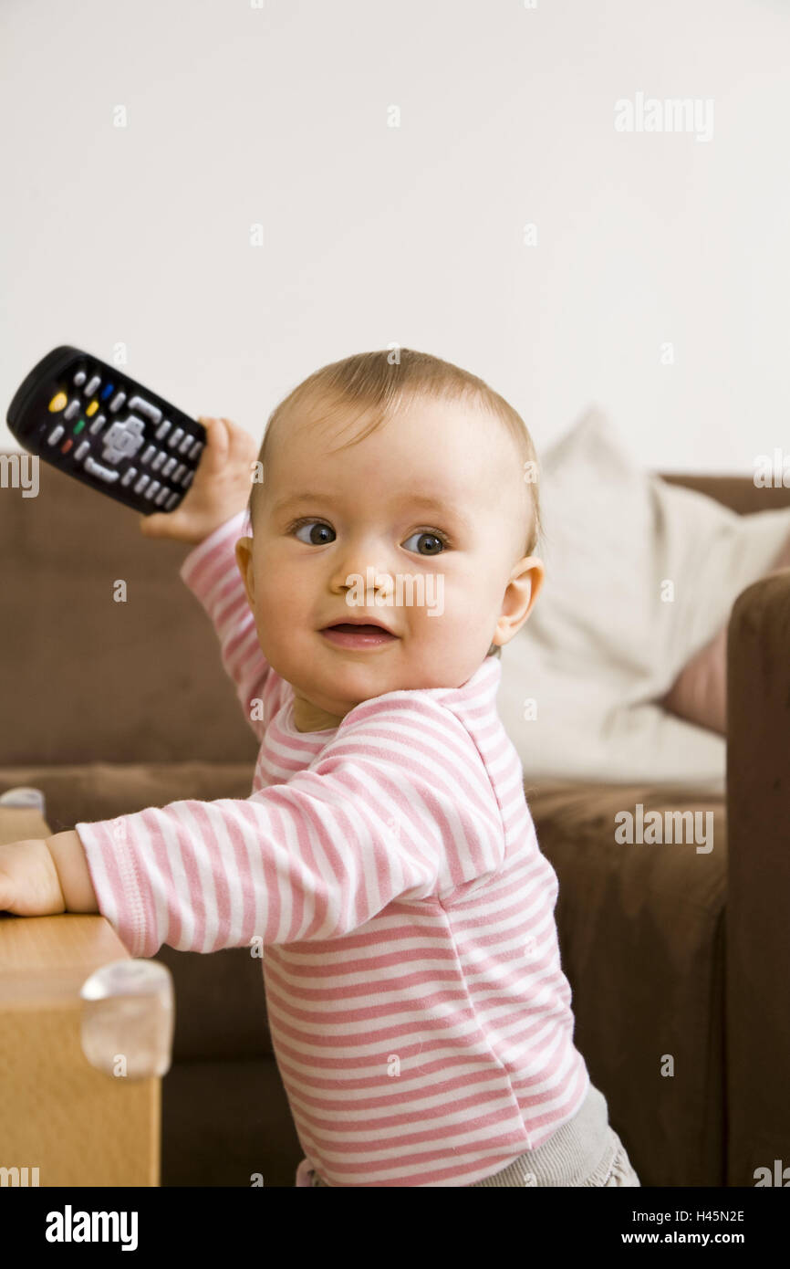 Baby, remote control, holding Stock Photo - Alamy