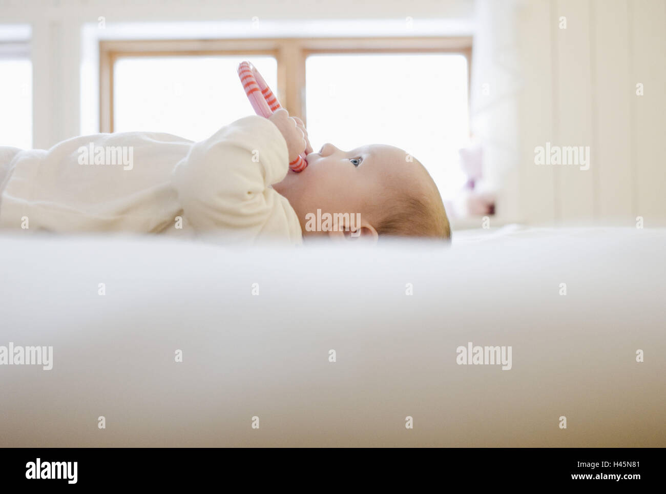 Baby, lie, mouth, teething ring, at the side Stock Photo - Alamy