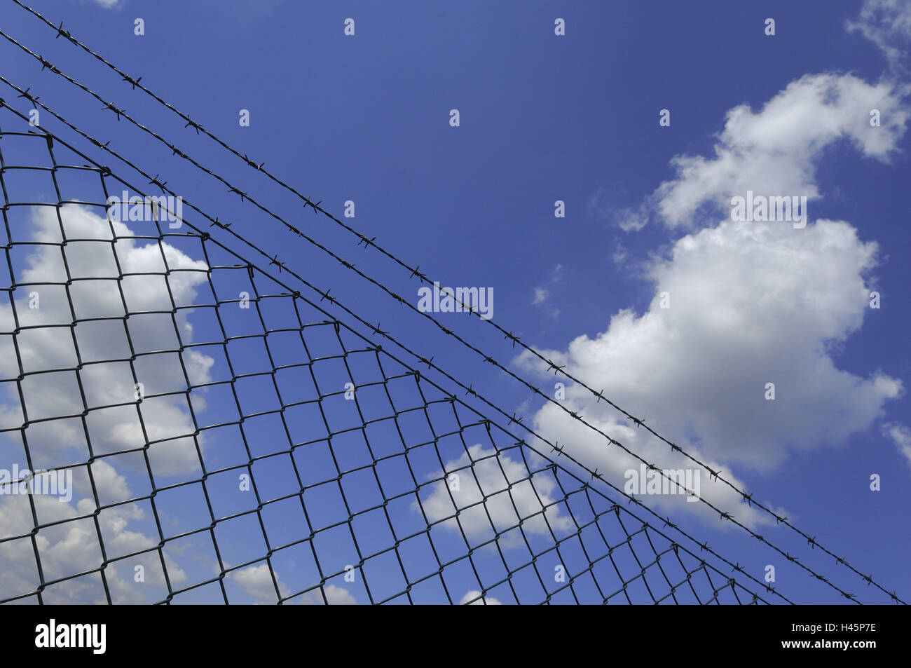 Mesh wire fence, barbed wire, heaven, clouds Stock Photo - Alamy
