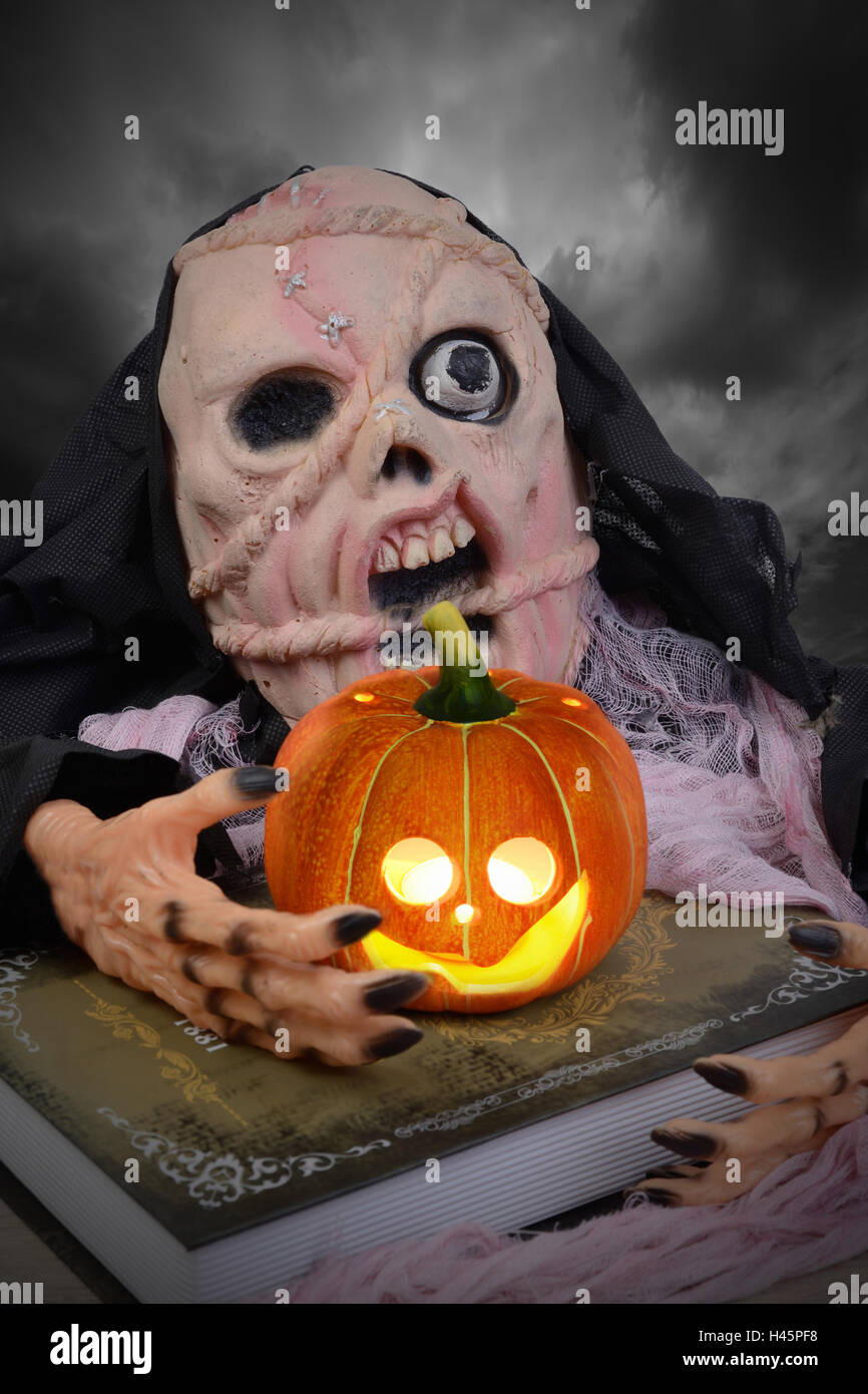 Ghost show scary face with halloween pumpkin and witch book in the dark ...