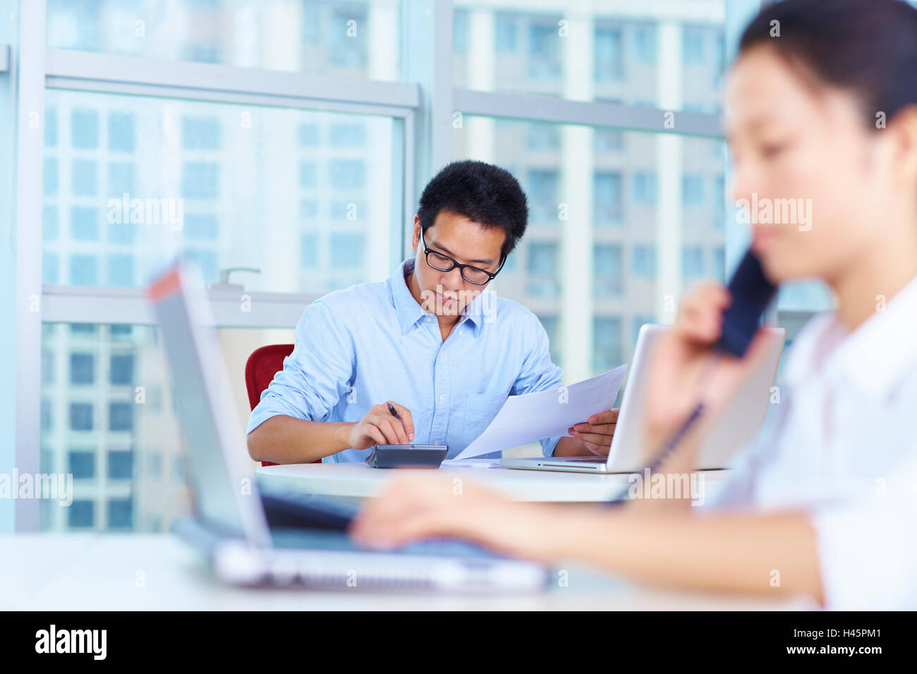 Two Young Asian business people in the Office Stock Photo - Alamy