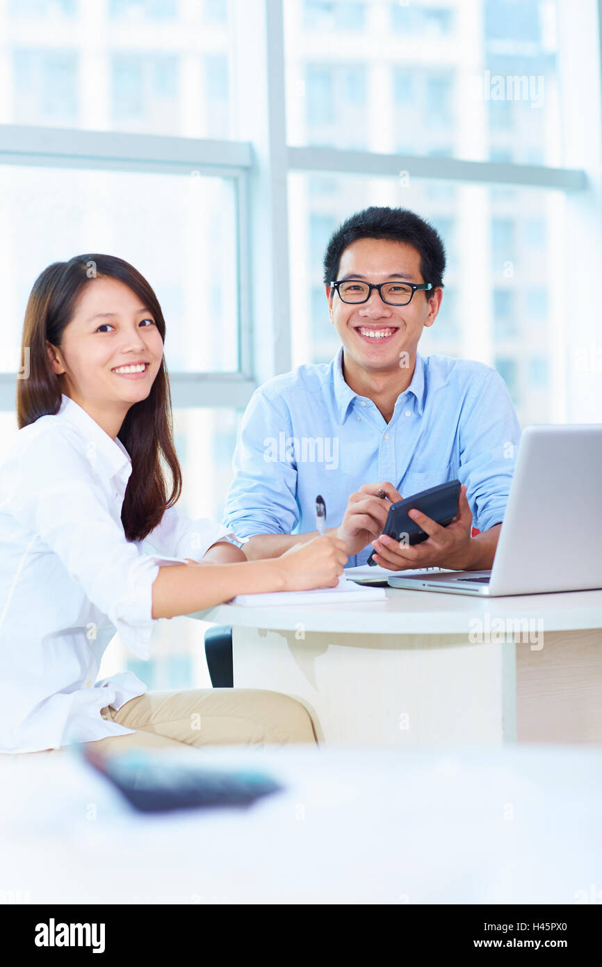 Two Young Asian business people in the Office Stock Photo - Alamy