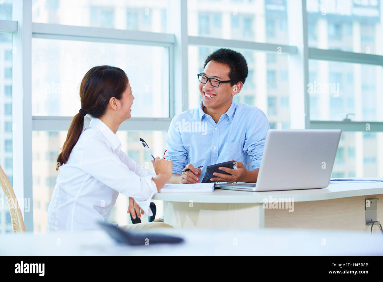 Two Young Asian business people in the Office Stock Photo - Alamy