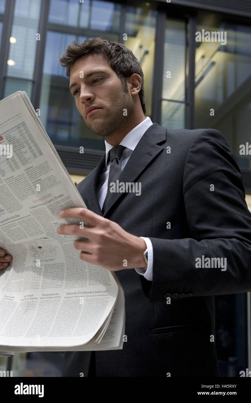 Sidewalk, businessman, newspaper, read, from below Stock Photo - Alamy