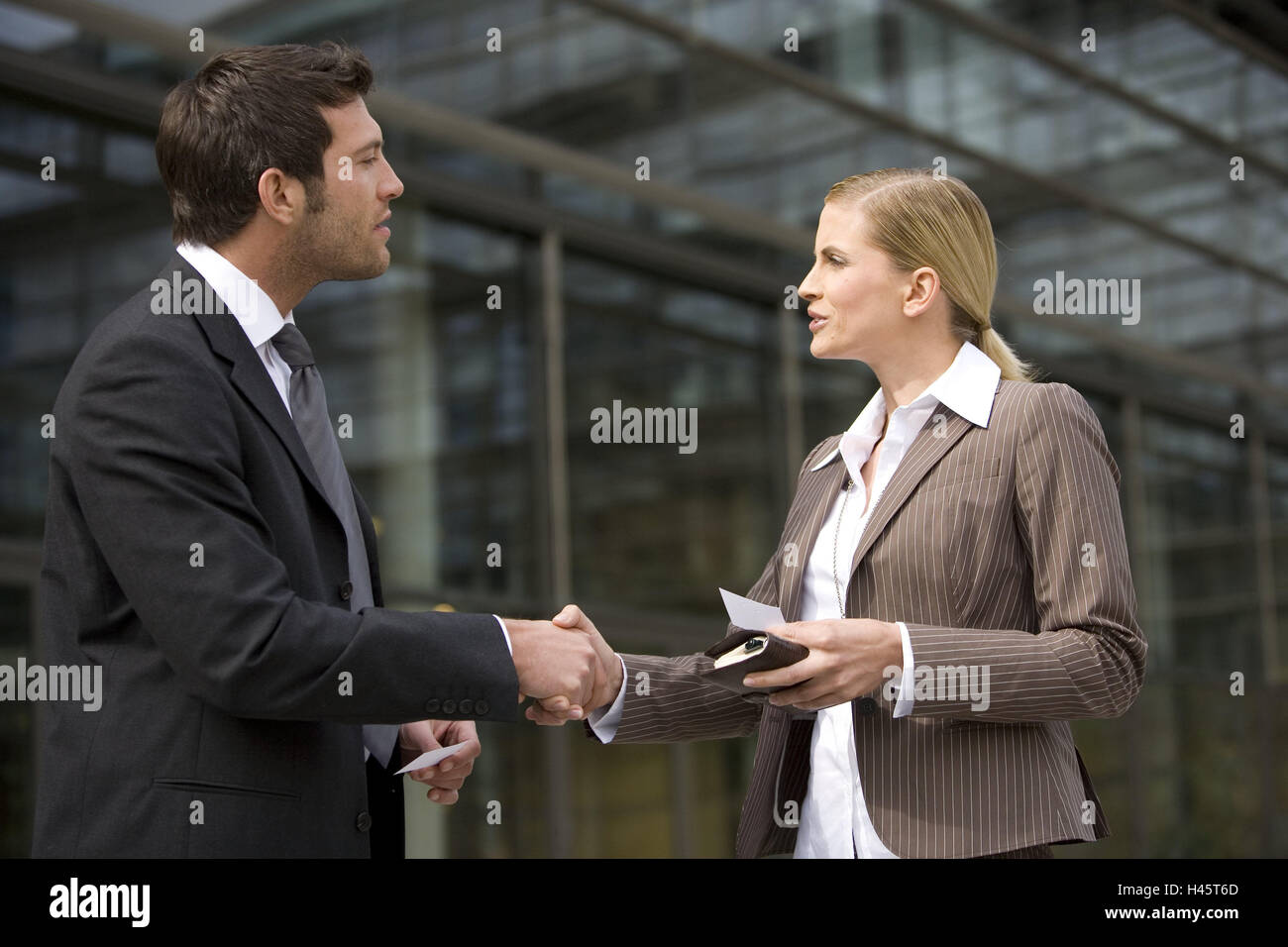 Office buildings, business people, conversation, handshake Stock Photo ...