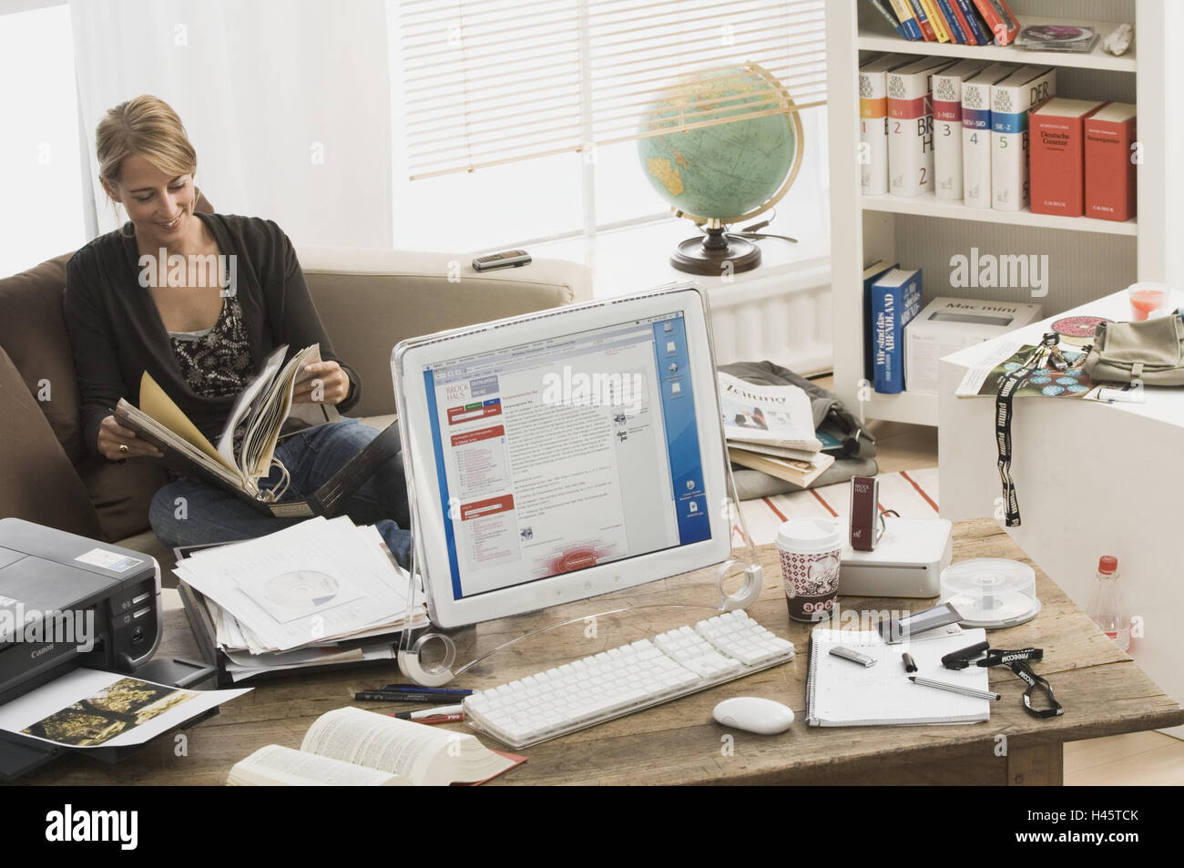 woman, young, sofa, sitting, stewards, records, desk, look at computers ...