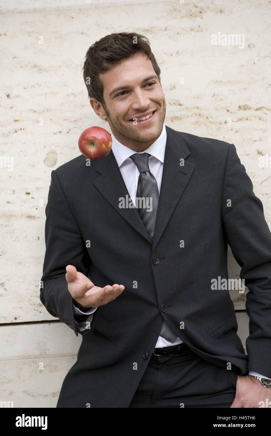 Businessman, apple, throw up, cheerful Stock Photo - Alamy