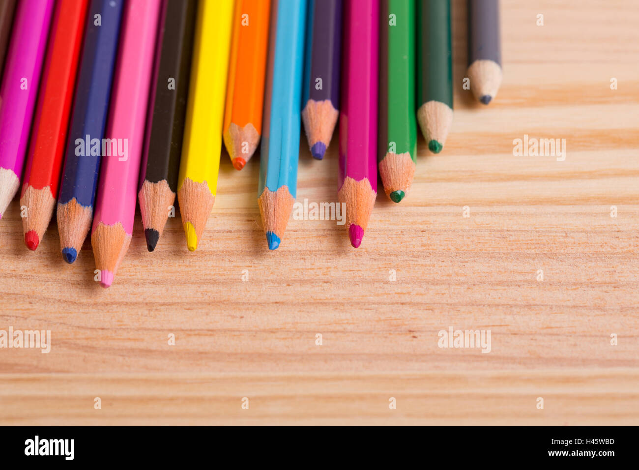 colored pencils on the wooden background Stock Photo - Alamy