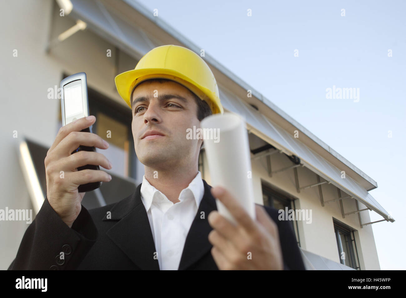 Architect, house, architect's plan, mobile phone, outside, portrait ...