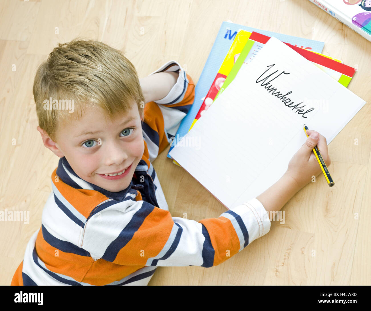 Boy, floor, lie, add support head, write, block, portrait Stock Photo ...