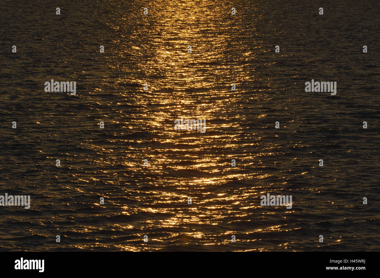 Sea, water surface, waves, evening light Stock Photo - Alamy