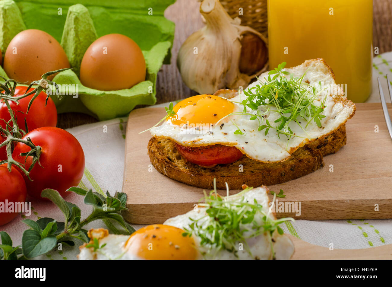 Healthy dinner - a panini garlic toast with fried egg, peanuts and ...