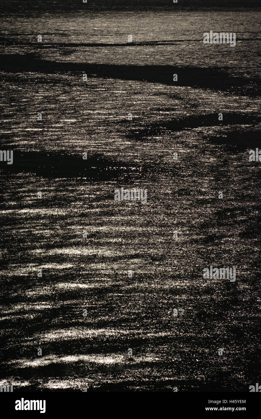 Light reflections over isolated sea waves at night Stock Photo - Alamy