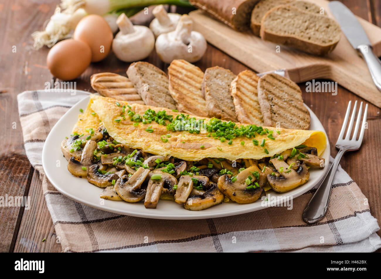 Rustic omelette with mushrooms on chives, roasted panini health bread ...