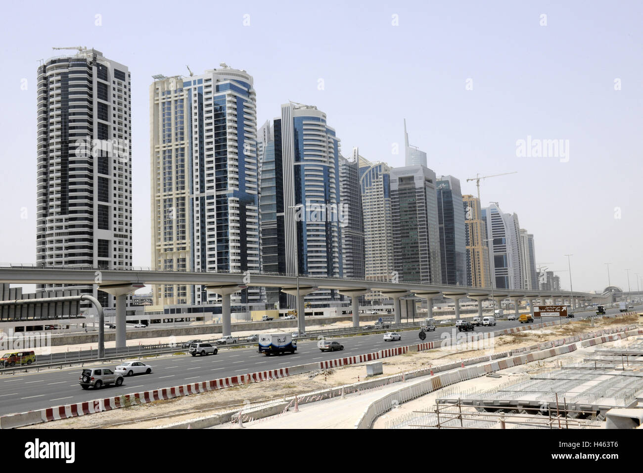 Street, high rises, cars, men at work, Dubai, United Arab Emirates ...