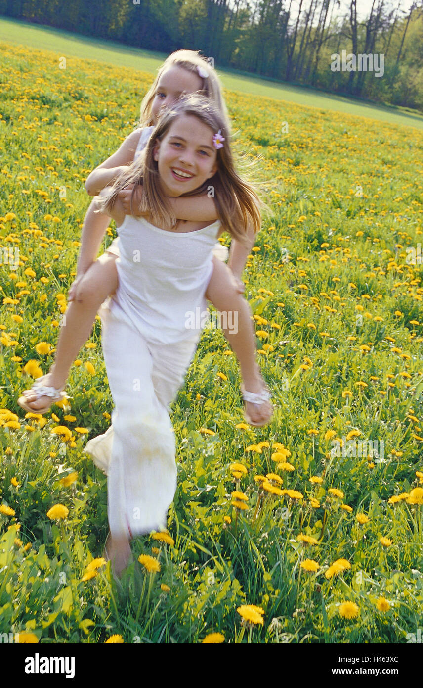 Girls, piggyback, flower meadow, dandelion, running, carrying Stock ...