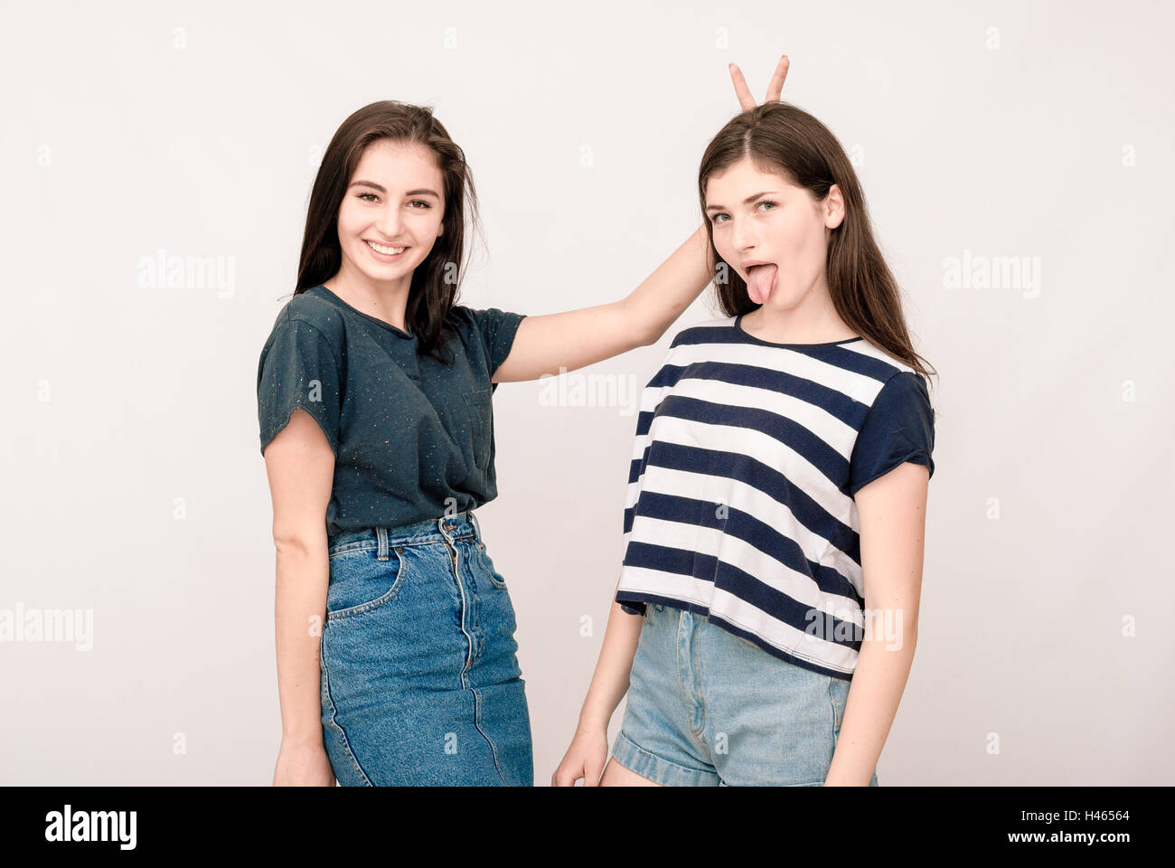 Positive friends portrait of two girls, funny faces, grimaces Stock ...