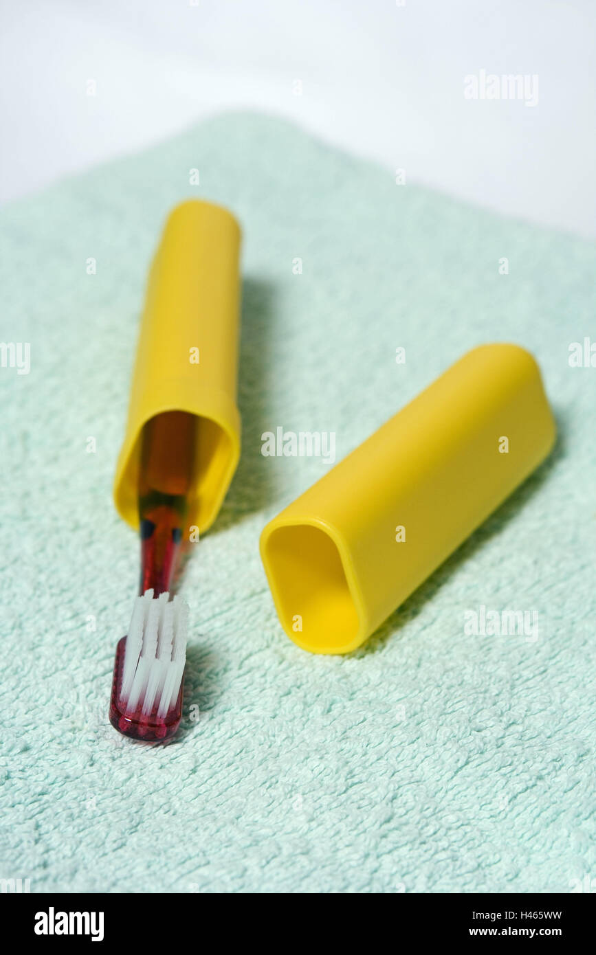 Towel, toothbrush, travel case, opened, background blur, hand ...