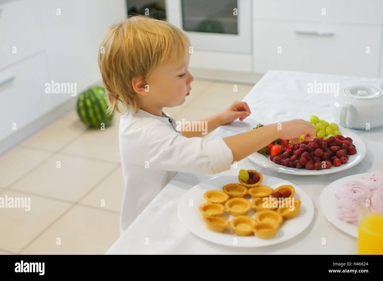 boy preparing breakfast in white kitchen Stock Photo - Alamy