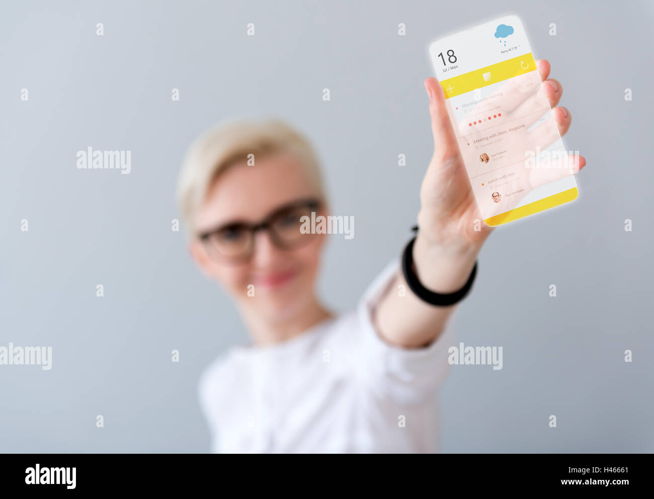 Positive woman holding cell phone Stock Photo - Alamy