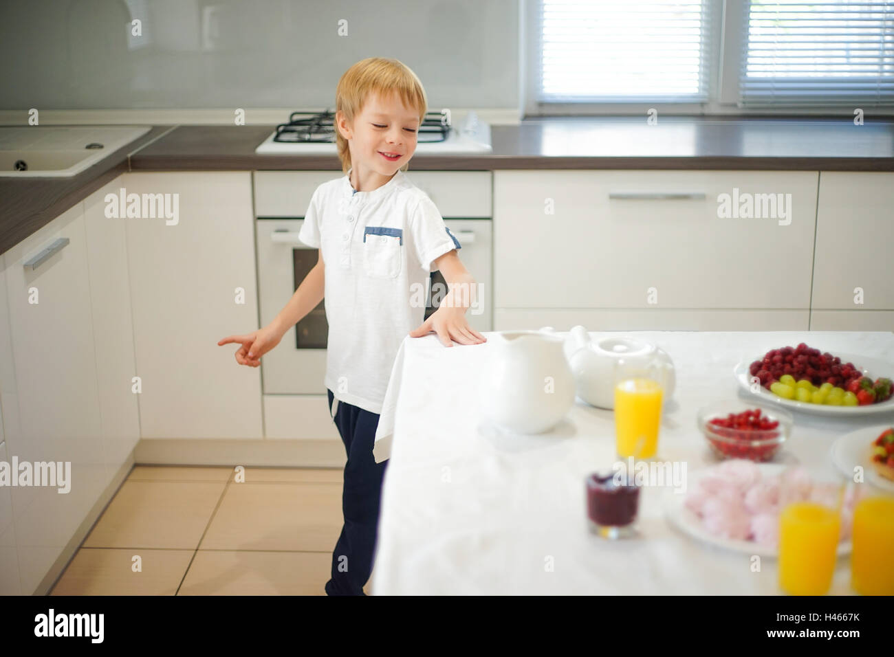 boy preparing breakfast in white kitchen Stock Photo - Alamy