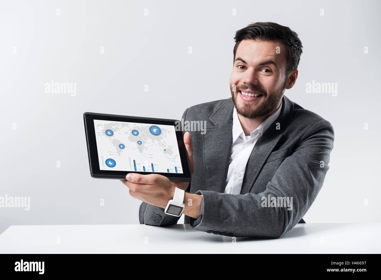 Smiling bearded man holding tablet Stock Photo - Alamy