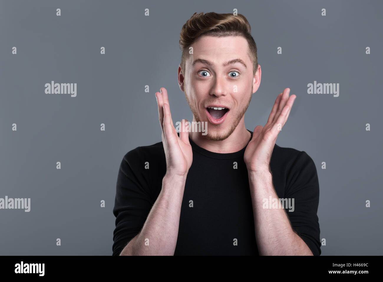 Surprised young bearded man Stock Photo - Alamy