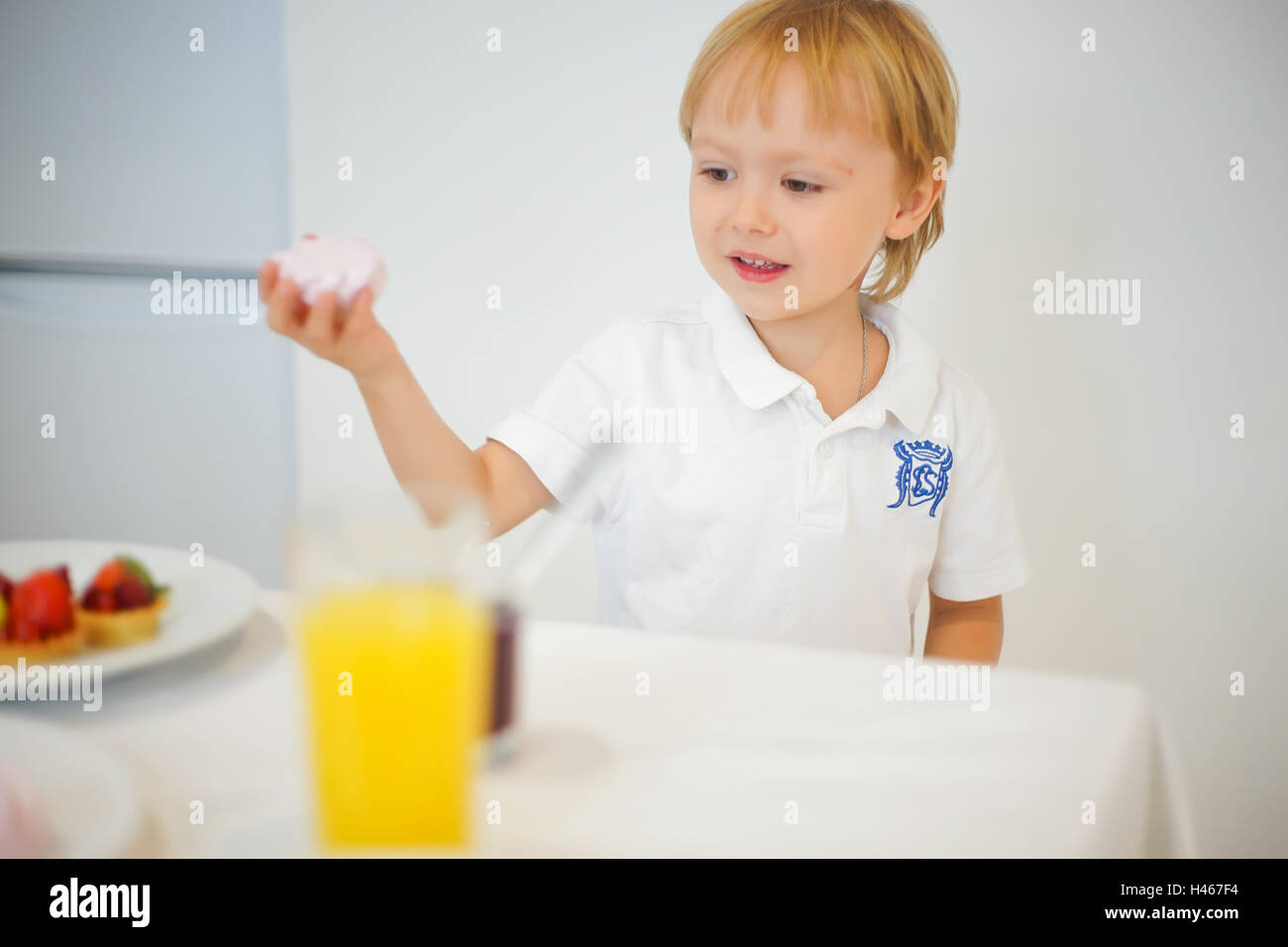 boy preparing breakfast in white kitchen Stock Photo - Alamy