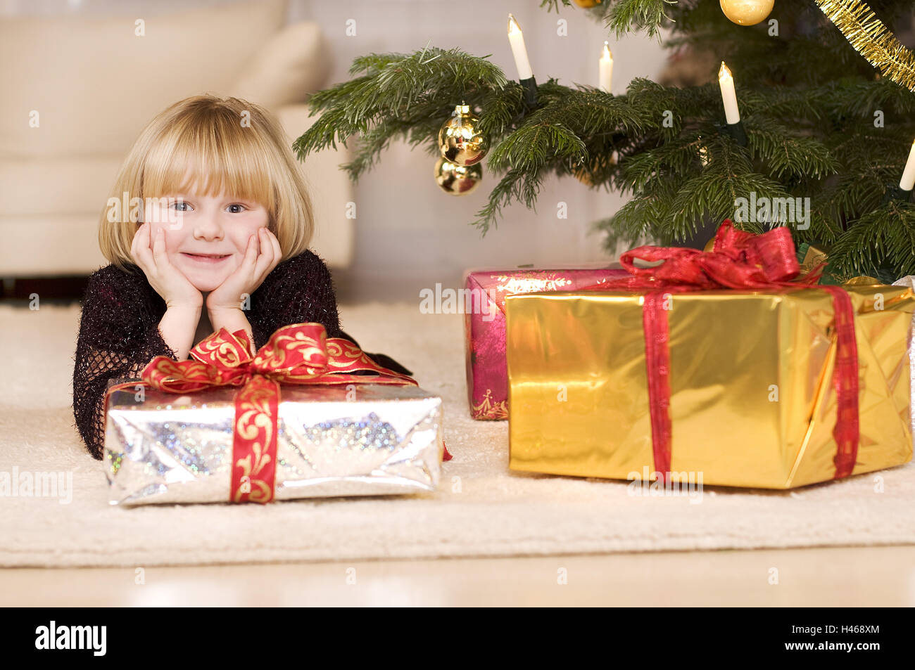 Girls, lie, smile, presents, carpet, prejoy Stock Photo - Alamy